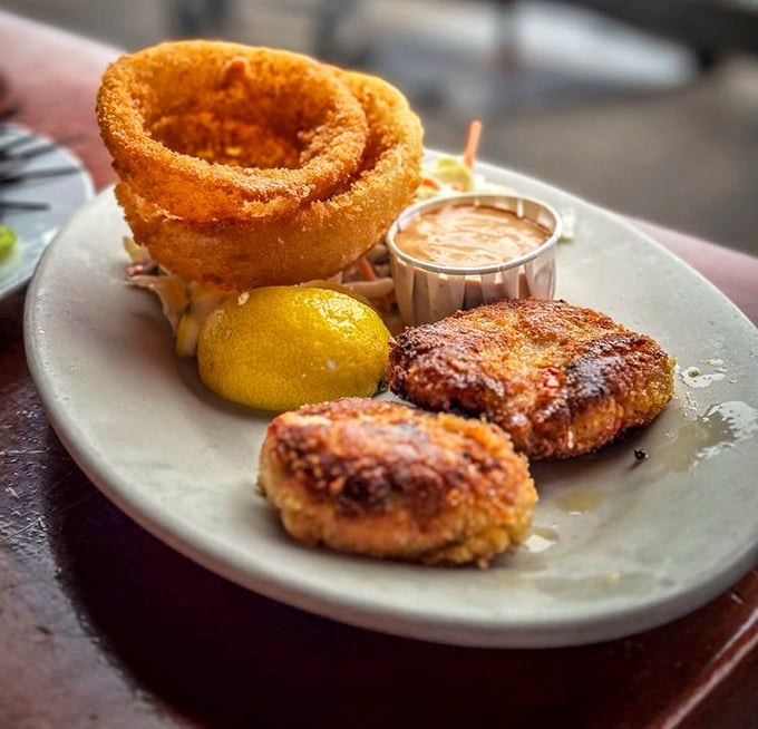 Crab cakes with the perfect golden crust, paired with onion rings that could double as edible jewelry.