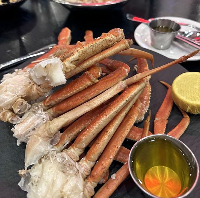 Crab legs arranged like nature's perfect eating puzzle – the only food that gives you tools, a workout, and satisfaction all in one package. 