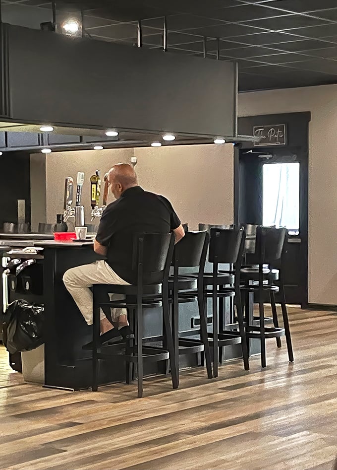 The bar area beckons with the promise of cold drinks and warm conversations with fellow food lovers.