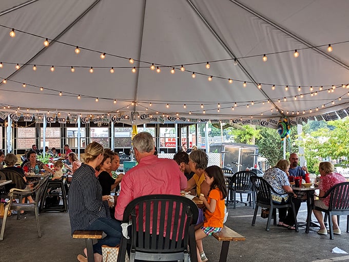 The outdoor tent dining area buzzes with conversation and laughter—proof that great food brings people together better than any fancy décor.