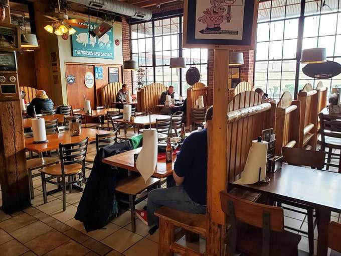 The wooden booths aren't just seating—they're front-row tickets to the greatest show on earth: your imminent food coma.