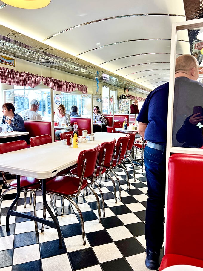 Where strangers become neighbors over breakfast. The curved ceiling creates the feeling of dining in a chrome cocoon of comfort food and conversation.