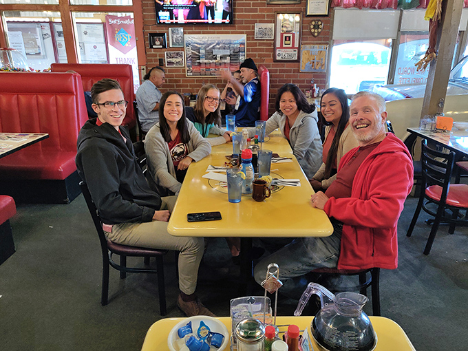 Happy faces around yellow tables—the universal sign that you've found a place where memories are made between bites of exceptional food.
