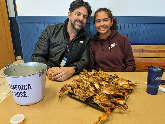 The true measure of great seafood? The smiles on diners' faces as they prepare to tackle a tray of perfectly seasoned crabs.