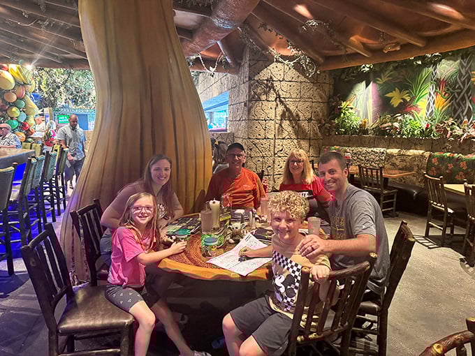 Families create memories that last longer than the meal itself, surrounded by the gentle glow of a jungle that never needs bug spray.