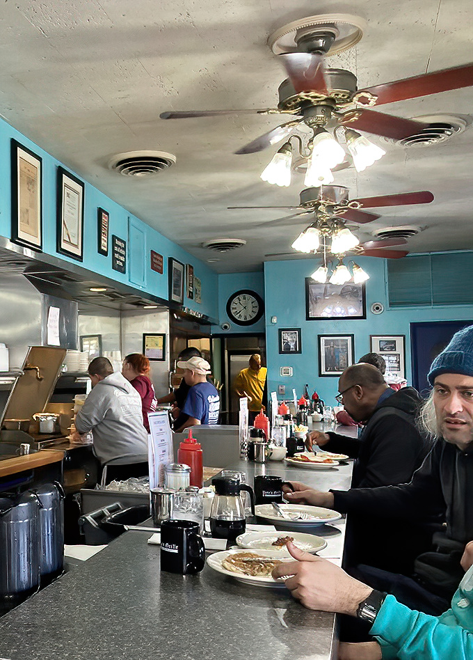 Morning communion at the counter, where regulars and newcomers alike bow their heads—not in prayer, but in devotion to perfectly cooked eggs and bacon.