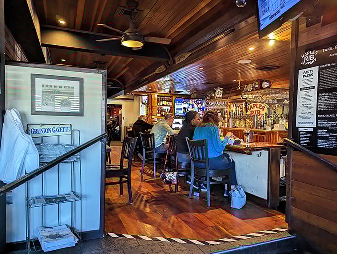 The bar area—where strangers become friends over shared appreciation of smoke, meat, and the occasional sports argument on the overhead TVs.
