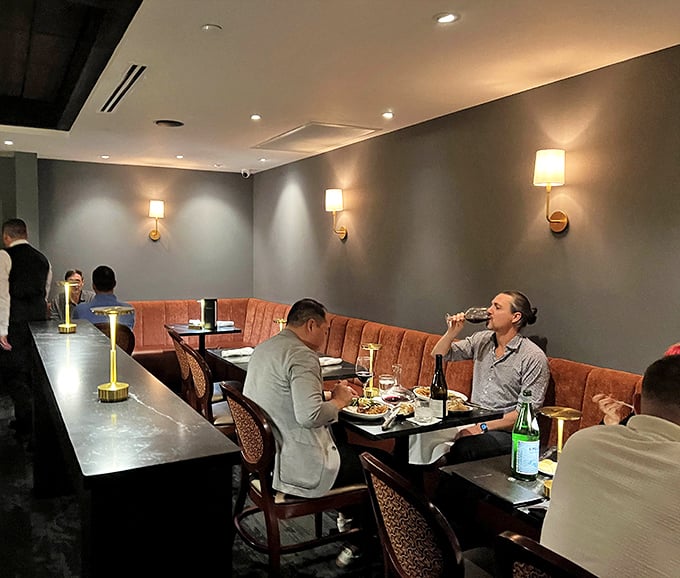 Diners engaged in the serious business of pleasure—notice how nobody's looking at their phones when there's steak to be contemplated.