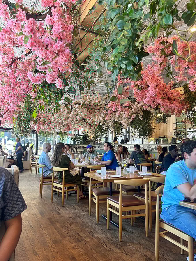 The restaurant buzzes with the energy of shared plates and conversation. Under those pink blossoms, strangers become friends and calories don't count.