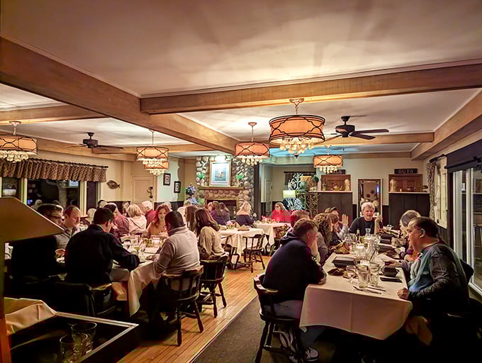 The dining room buzzes with that magical energy that happens when good food meets good company under copper-accented chandeliers.