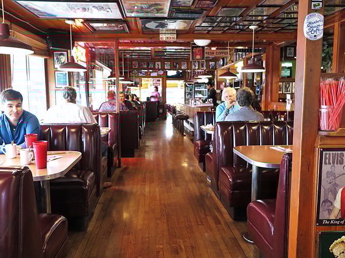 The diner's central aisle—a runway of comfort food possibilities where servers perform the ballet of balanced plates and coffee refills.