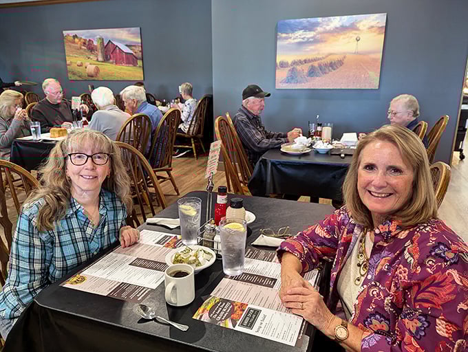 Where rural artwork meets hearty appetites. The paintings aren't just decoration—they're windows into the world that produces your meal.