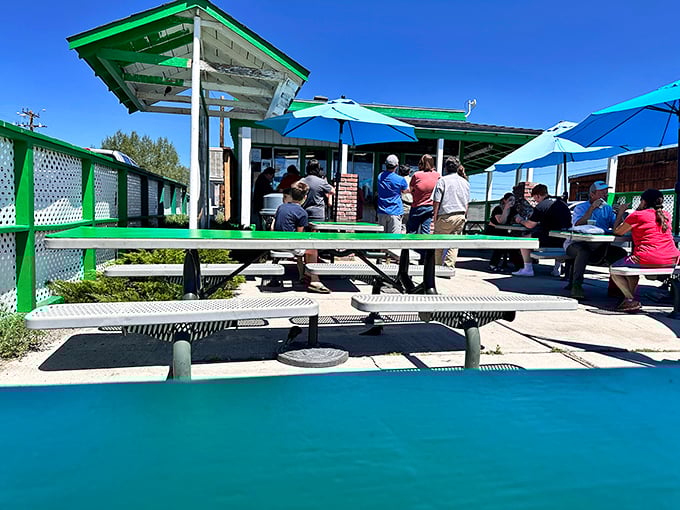 Blue umbrellas shield hungry patrons from the high-altitude sun while they wait for burgers that will make the brief line seem like time well invested.