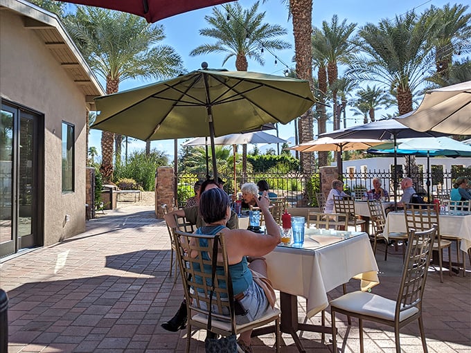 The outdoor patio offers date palm views and desert breezes—nature's air conditioning with a side of agricultural heritage.