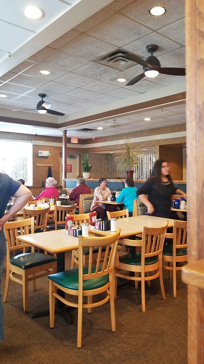 Where strangers become neighbors over coffee and toast – the dining room hums with the soundtrack of community.