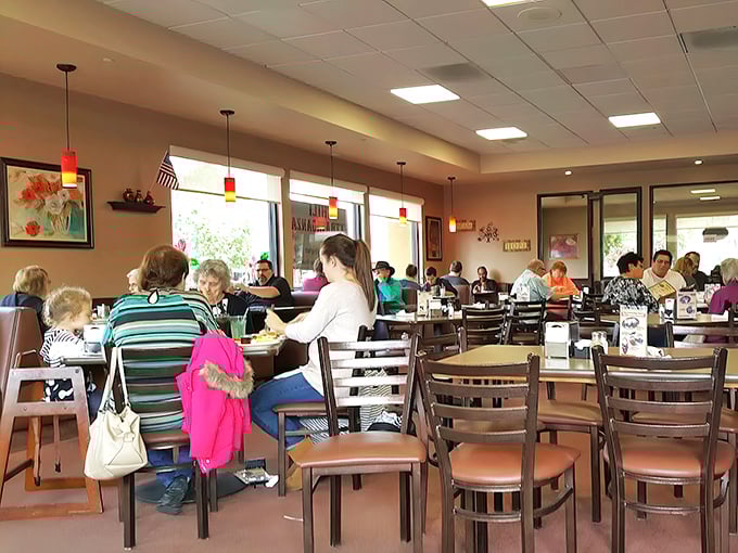 The dining room hums with the symphony of clinking forks and conversation – the soundtrack to community happening over coffee refills.