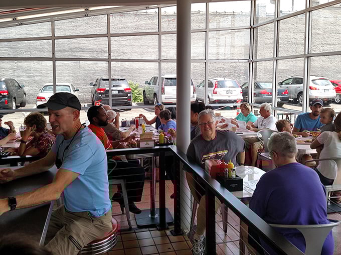 Happy diners filling the sunlit space—proof that good food creates community faster than any social network.