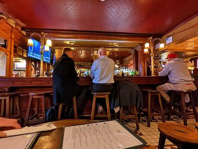 The bar scene at The Ugly Oyster—where strangers become friends and friends become family, all over properly poured pints and shared stories.