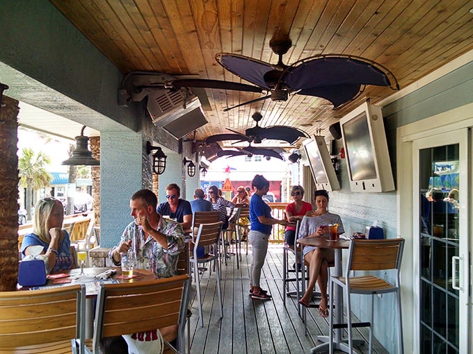 The outdoor deck—where vacation vibes are mandatory and strangers become friends over shared recommendations and ocean breezes.
