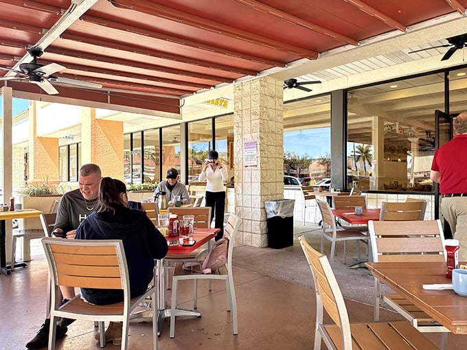 The covered patio offers al fresco dining without the sunburn. Perfect for people-watching while debating whether to order seconds.