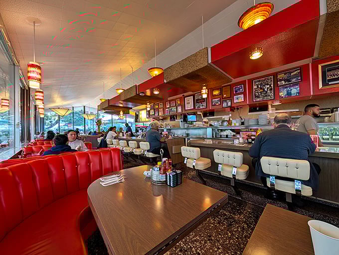 Red vinyl booths and vintage lighting create the perfect backdrop for conversations that somehow feel more meaningful than anywhere else.