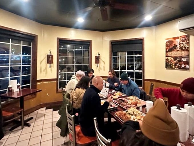 Happy diners huddled around trays of BBQ goodness—this is what contentment looks like in its natural habitat.