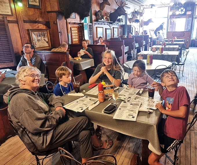 Three generations sharing one table – the universal language of good food bringing families together since before smartphones made conversation obsolete.