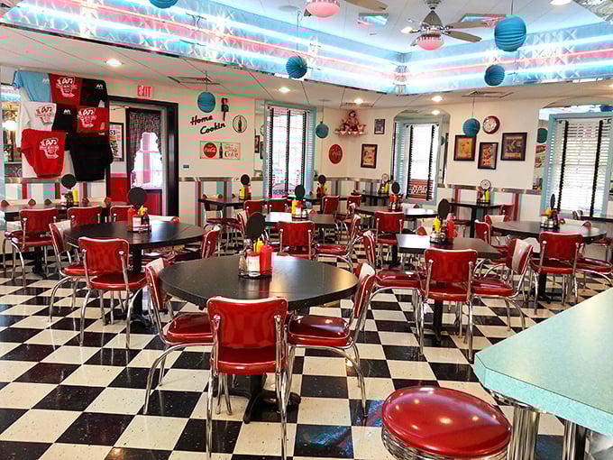 The checkerboard floor plays perfect counterpoint to those cherry-red chairs, creating a dining room straight out of Happy Days—minus the Fonzie.