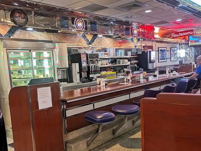The counter experience—where solo diners become regulars, servers become friends, and breakfast becomes theater with a front-row seat to the action.