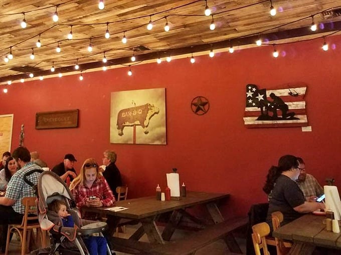 Red walls adorned with BBQ art and string lights create the perfect backdrop for the main attraction—meat so good it deserves its own museum.