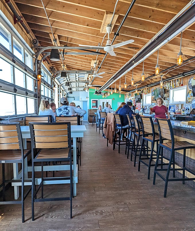 Wooden beams, natural light, and happy diners – the holy trinity of coastal restaurant perfection.