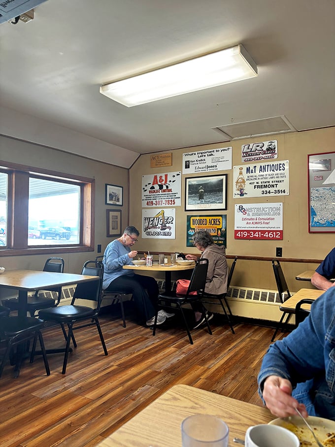 Local business ads line the walls, creating that authentic community bulletin board vibe that chain restaurants spend millions trying to replicate.