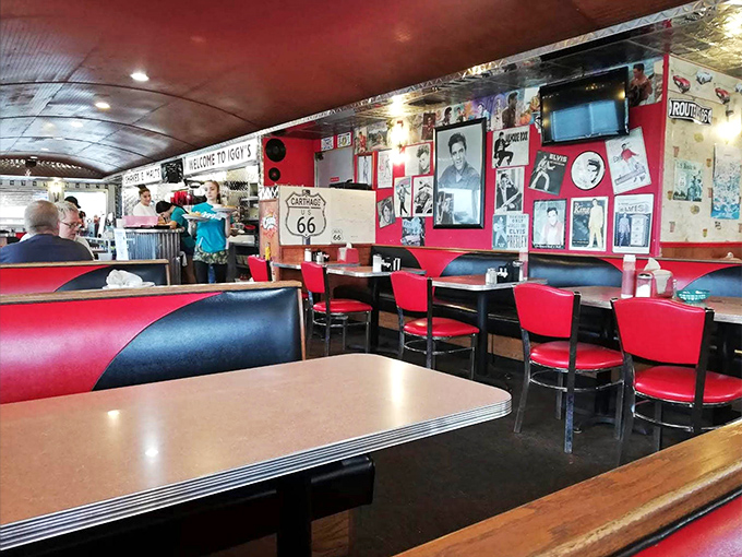 Red and black booths set against walls of nostalgia—where conversations flow as freely as the coffee refills.