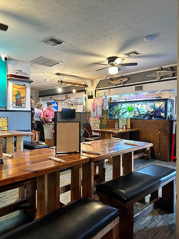 Rustic wooden tables, bench seating, and an aquarium in the corner—because nothing builds appetite for seafood like watching fish swim by.