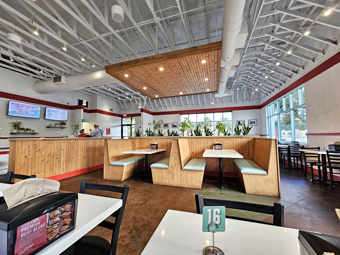 Wooden booths, clean lines, and that signature red stripe—Hugh-Baby's dining area feels like the perfect blend of nostalgic diner and modern eatery.
