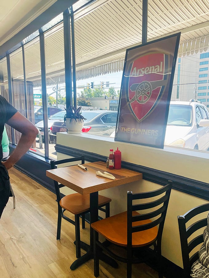 That Arsenal poster in the window tells you everything – this is a place where sports fans and foodies find common ground.