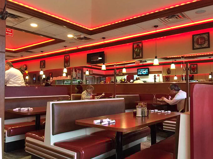 The red booths aren't just seating – they're front-row tickets to the greatest show on earth: breakfast served all day.