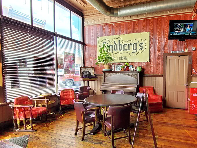 Red chairs that have cradled countless conversations, beneath a sign that promises exactly what you need – food and drink.