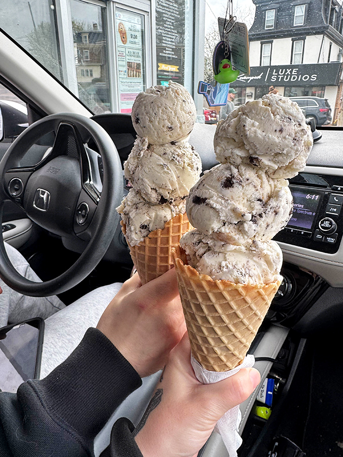 Car dashboard dining at its finest. Four scoops of cookies and cream—one for the road and three because life is short.
