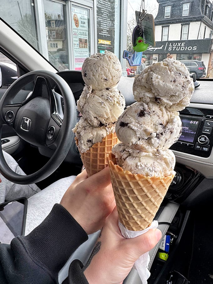 Car dashboard dining at its finest. Four scoops of cookies and cream—one for the road and three because life is short.