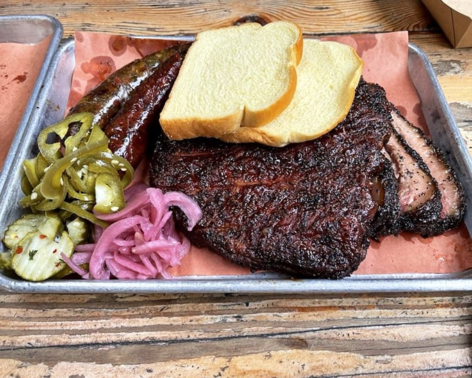 The holy trinity of barbecue: perfectly smoked brisket, pickled vegetables, and white bread. Simple, traditional, and absolutely transcendent.