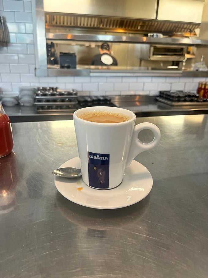 Not just coffee—a proper espresso that would make an Italian nod in approval. The kitchen view reminds you this is serious breakfast business.