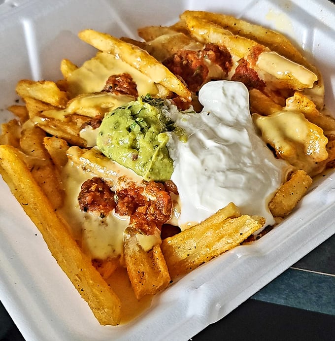 Loaded fries that don't understand the concept of moderation – cheese, guacamole, and sour cream in delicious harmony.