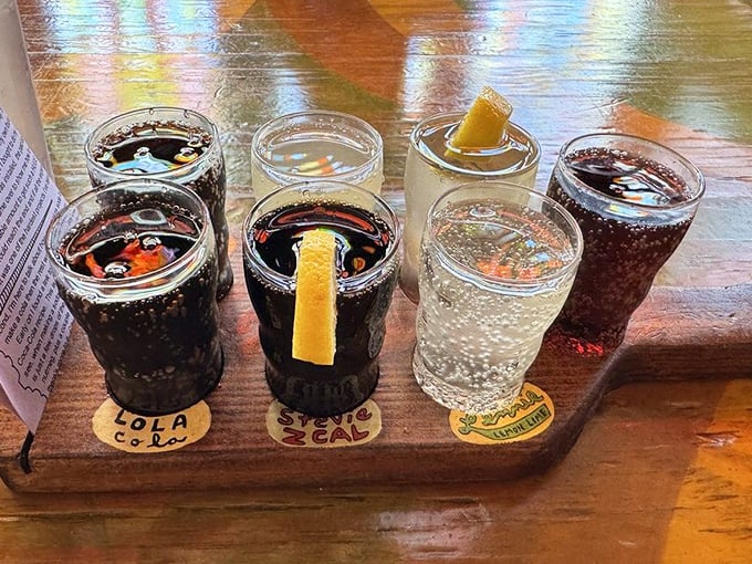 Seven sodas lined up like liquid happiness, because sometimes one flavor just isn't enough adventure.
