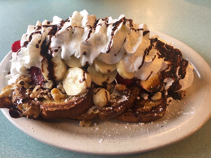 French toast that's having an identity crisis as a dessert—and we're not complaining. Whipped cream, bananas, and chocolate drizzle turn breakfast into celebration.