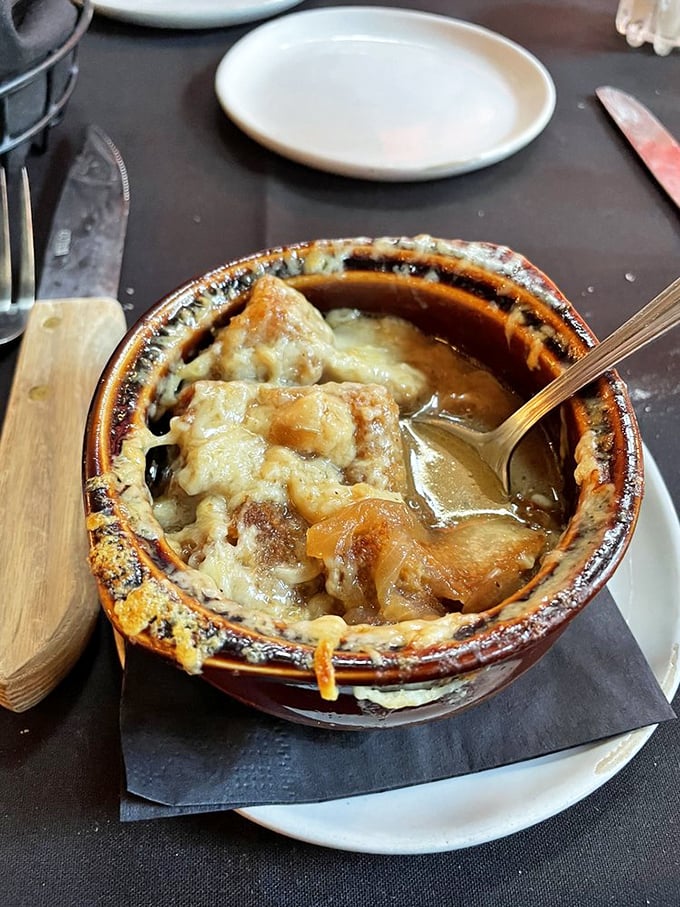 French onion soup that's had a proper education—bubbling cheese, rich broth, and bread that's soaked up all the right lessons.