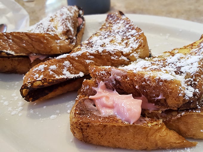 Stuffed French toast that oozes strawberry filling—the breakfast equivalent of finding an extra twenty in your winter coat pocket.