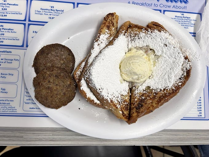 French toast dusted with powdered sugar snow and crowned with butter. Those sausage patties standing guard ensure you won't leave the table hungry.