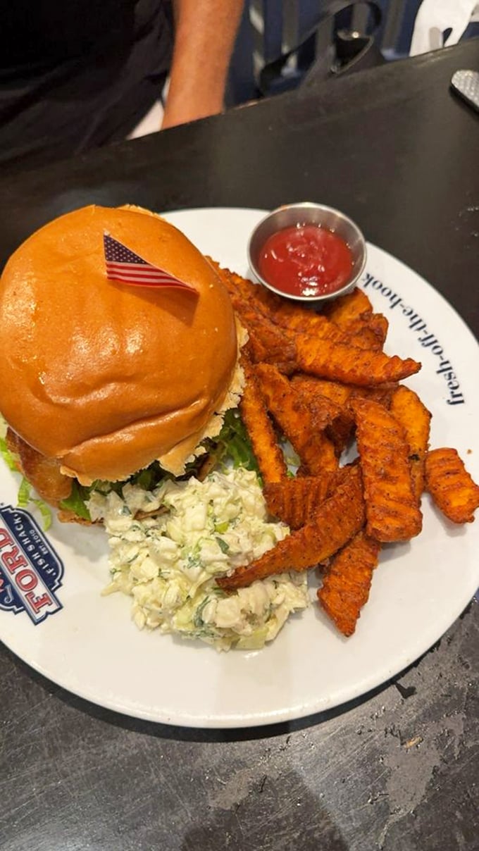 This sandwich waves its tiny American flag with patriotic pride, as if to say, "This is what freedom tastes like – with a side of slaw."