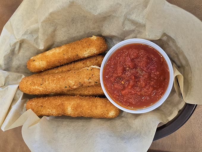 These cheese sticks aren't just appetizers, they're an event—golden-brown sentinels guarding a pool of marinara that begs for a dramatic dip.